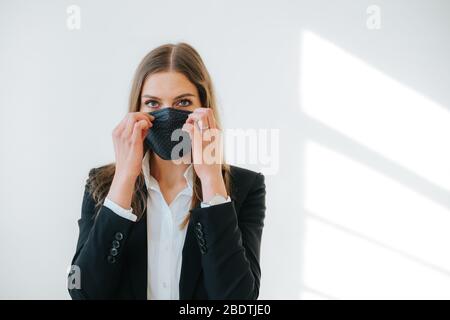 photo of successful business woman putting on a breathing mask Stock ...
