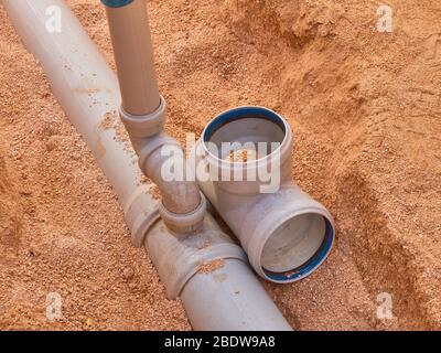Junction of plastic sewer pipes. Sewage pipeline system of residential ...