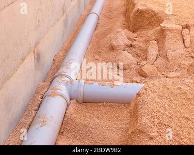 Junction of plastic sewer pipes. Sewage pipeline system of residential ...
