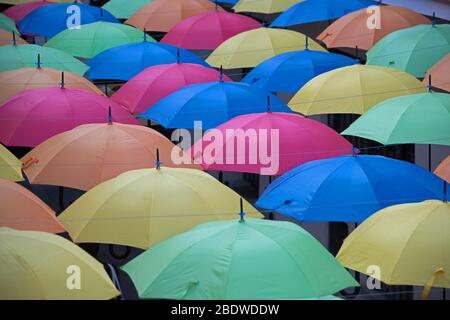 Many bright multicoloured umbrellas seen from above Stock Photo - Alamy