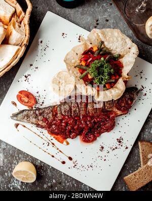 Salmon fillet with fresh salad and sauce at white Stock Photo - Alamy
