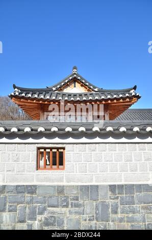 A traditional Korean wall with decorative wooden elements and tiles ...