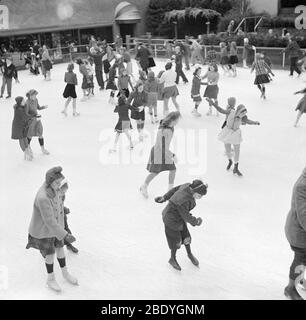 Kids ice skating in winter park rink. Children ice skate on Christmas ...