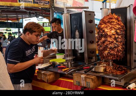 A chicken shawarma skewer roasting on a rotating pole Stock Photo - Alamy