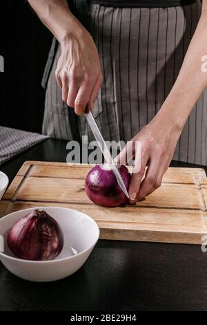 Closeup shot of a person cutting an onion into slices Stock Photo - Alamy