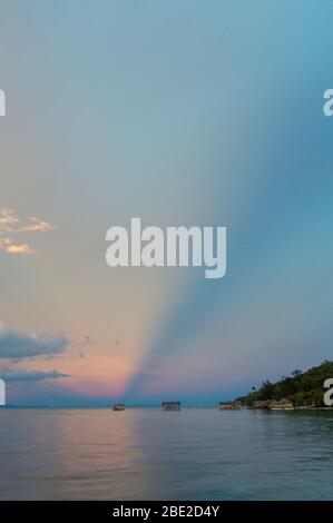 sunset over tropical island raja ampat, Indonesia Stock Photo - Alamy