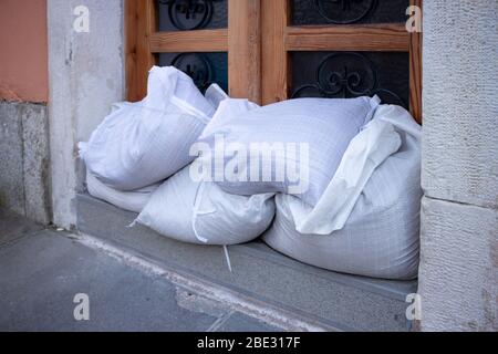 Sandbags stacked in front of doors to protect against flooding of river ...