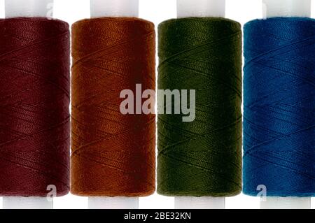 Hanks of multi-coloured threads for embroidery on a white background ...
