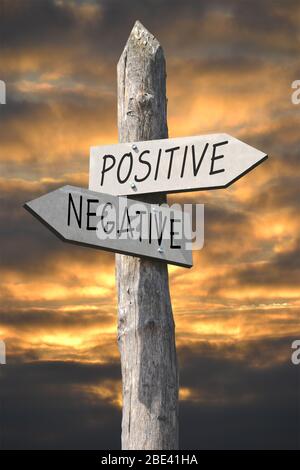 Negative or positive - wooden signpost Stock Photo - Alamy