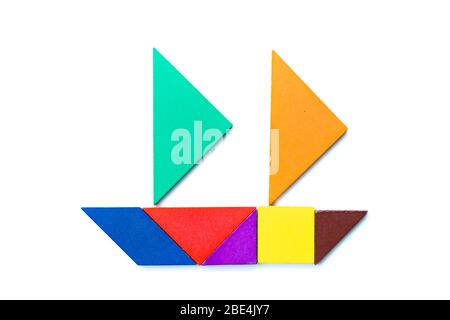 Colorful tangram puzzle in sailing boat shape on wood background Stock ...