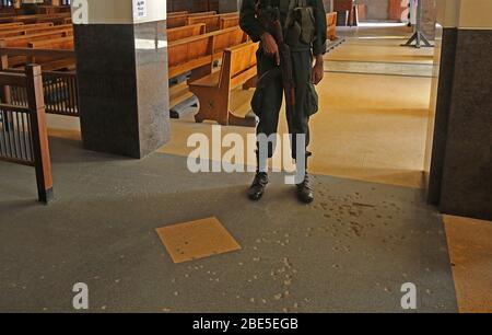 A Sri Lankan army soldier stands guard during the funeral ceremony of ...