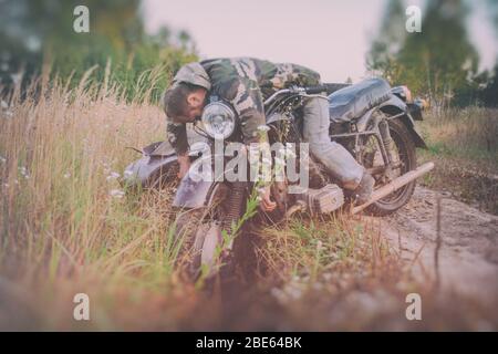 Drunk man in a motorcycle with a sidecar got stuck on the road Stock ...