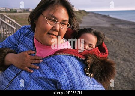 Inupiaq Inuit woman with baby in papoose and toddler in matching ...