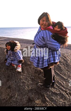 Inuit woman with her baby in traditional Amauti dress in North Americas ...
