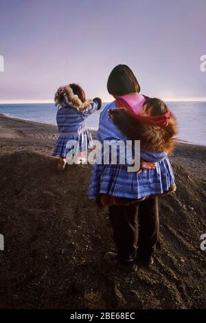 Inuit woman with her baby in traditional Amauti dress in North Americas ...