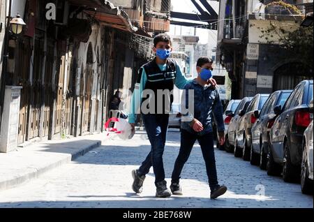 Damascus, Syria. 12th Apr, 2020. Kids wearing masks are seen in ...