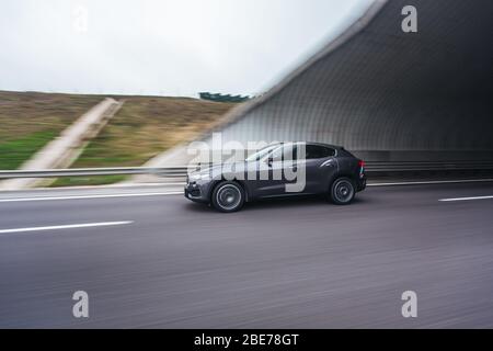 Grey offroader sport car driving over the bridge in the dusk Stock ...