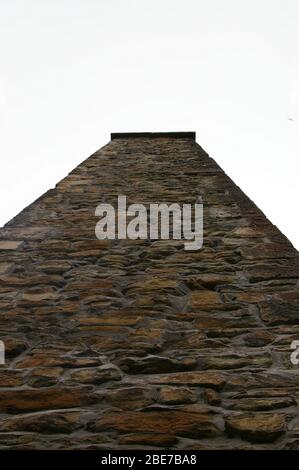 A tall tower with a stone base and a stone top. The tower is surrounded ...