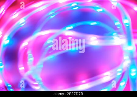 Futuristic blurred neon drop in blue and pink with traces of palm ...