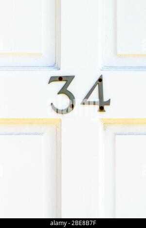 House number 34 thirty four plate on brickwall texture closeup Stock ...