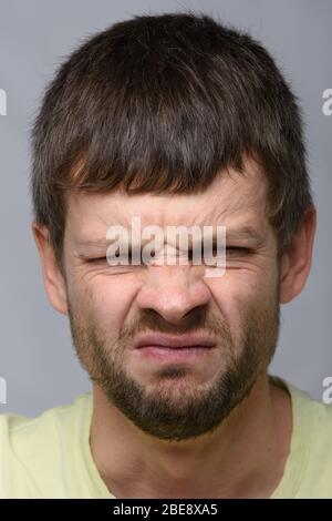 Man with disgust emotion close up face. Portrait of a person with ...