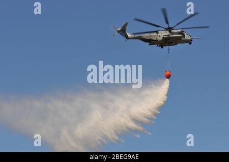 Helicopter drops water during exercise Stock Photo - Alamy