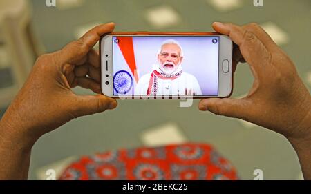 Woman watches Indian Prime Minister Narendra Modi's address to the ...