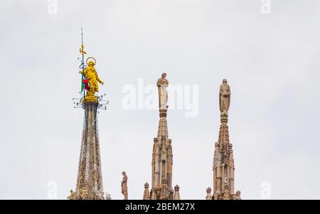 Golden Madonna statue and spires on the rooftop of the gothic Cathedral ...