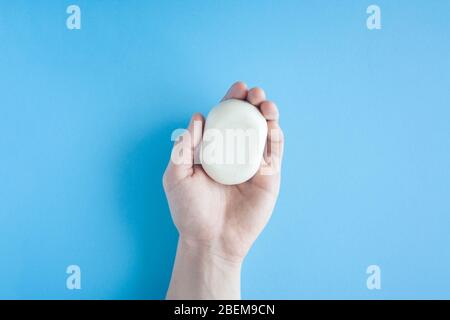 Hand holds blue soap bar in market basket Stock Photo - Alamy