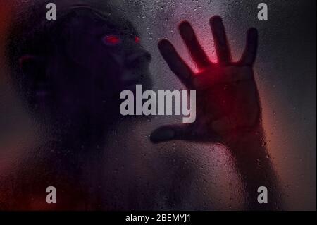 Bloody hand against wet shower glass. Horror concept. Toned image Stock ...
