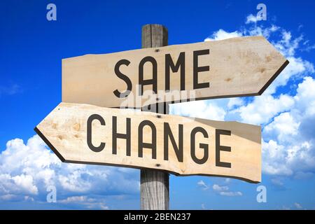 Change, same - wooden signpost, roadsign with two arrows Stock Photo ...