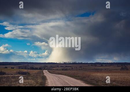 Cumulus cloud with snow, rain streaks at sunset, beautiful landscape ...