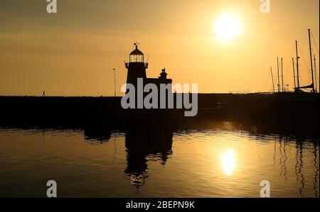 The sun rises above the Howth lighthouse in Dublin Stock Photo - Alamy