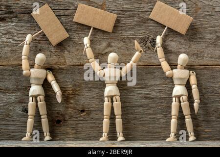 Wooden men holding blank banners. Men with placard signal. Protesters ...