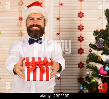 Man with beard holds striped present box with champagne glass Stock ...