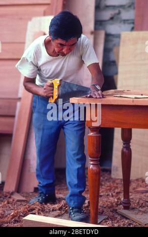 LIMA, PERU - Man works on furniture in small carpentry shop in Lima ...