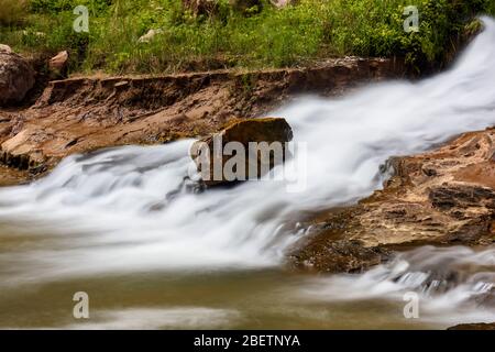 Vasey's Paradise waterfall pouring out of sandstone walls near the Colorado River, Grand Canyon ...