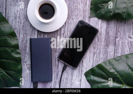 charging smartphone with power bank, high angle view Stock Photo - Alamy