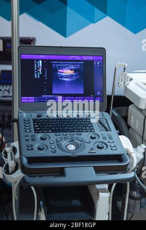 Sonographer operating ultrasound machine while scanning young pregnant ...