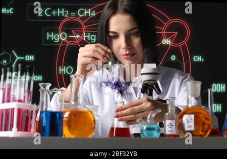 Female alchemist making potions in laboratory Stock Photo - Alamy