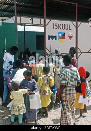 1993 - Children gather outside of a school house in Belet Uen, Somalia ...