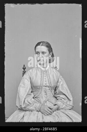 This portrait photograph features an unidentified woman, capturing a ...