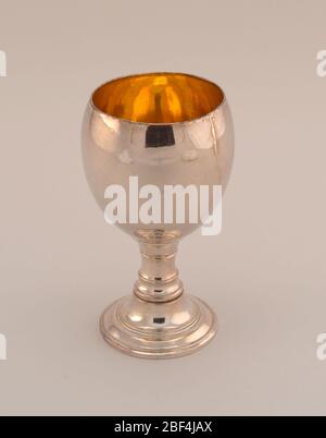This goblet is a metal drinking vessel with a stem and base, decorated ...