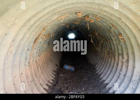 Drainage pipe. Culvert under small road. Drainage ditch and pipes in ...