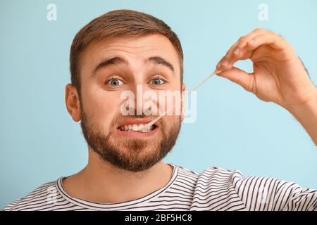 Funny man with chewing gum on color background Stock Photo - Alamy