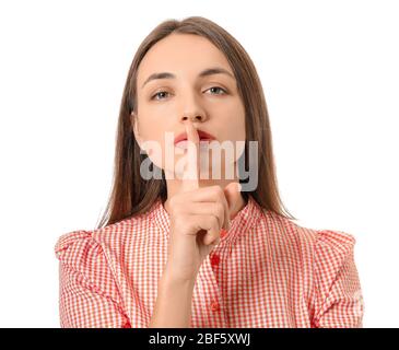 Young woman showing silence gesture while posing with balloons and ice ...