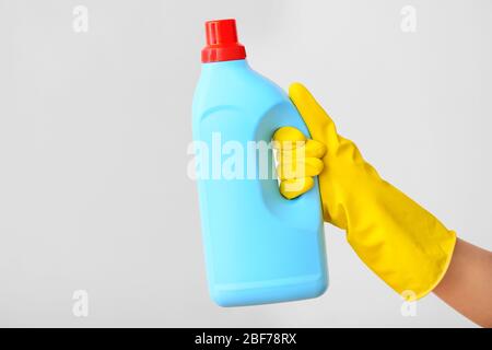 Hand of janitor with detergent on light background Stock Photo - Alamy