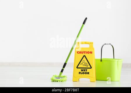 Caution sign with cleaning supplies indoors Stock Photo - Alamy
