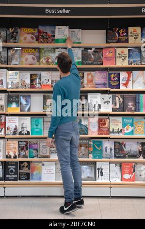 a customer picking up a book Stock Photo - Alamy