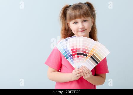 Little girl with color palettes on white background Stock Photo - Alamy
